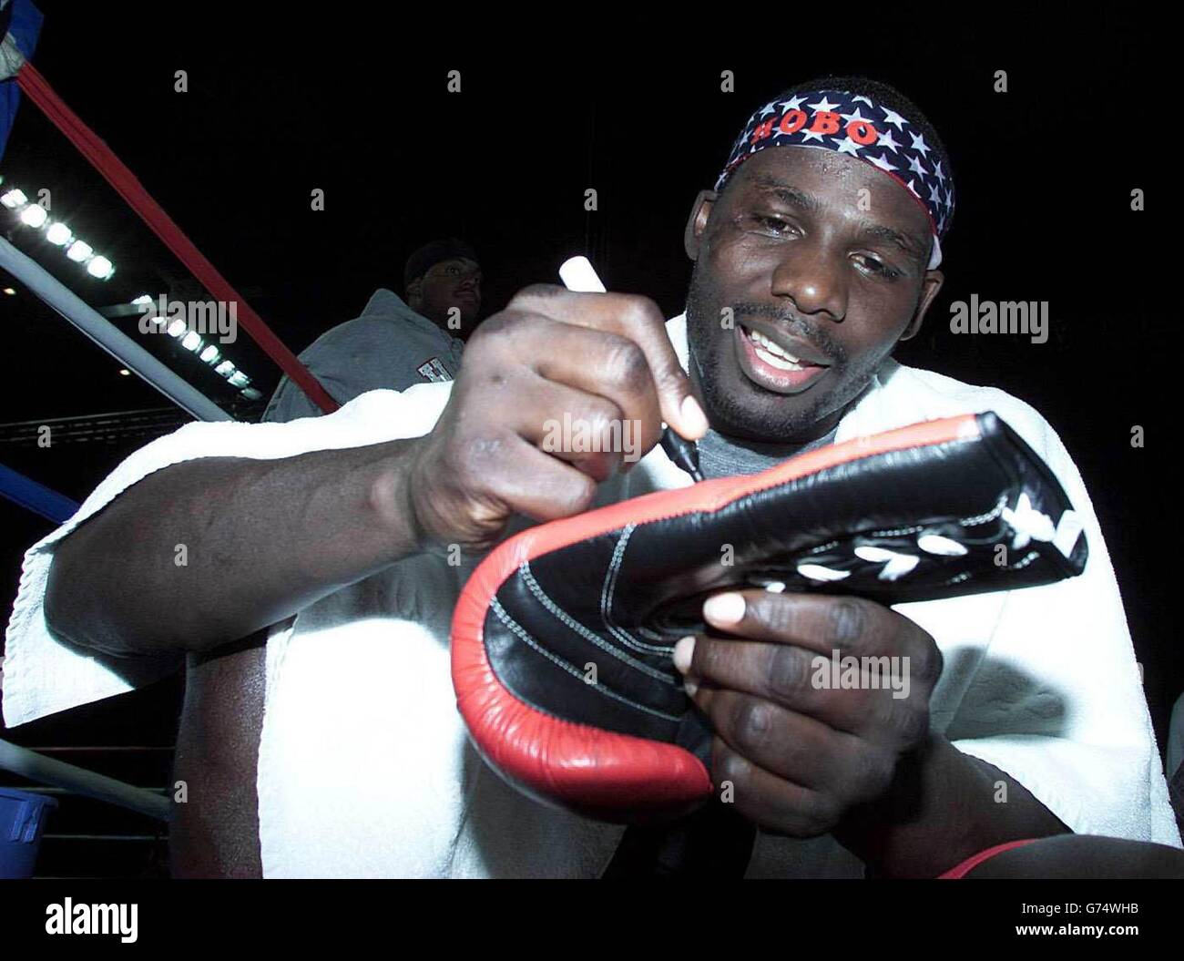 World Heavyweight Boxing Champion Hasim Rahman signs a glove for a fan ...