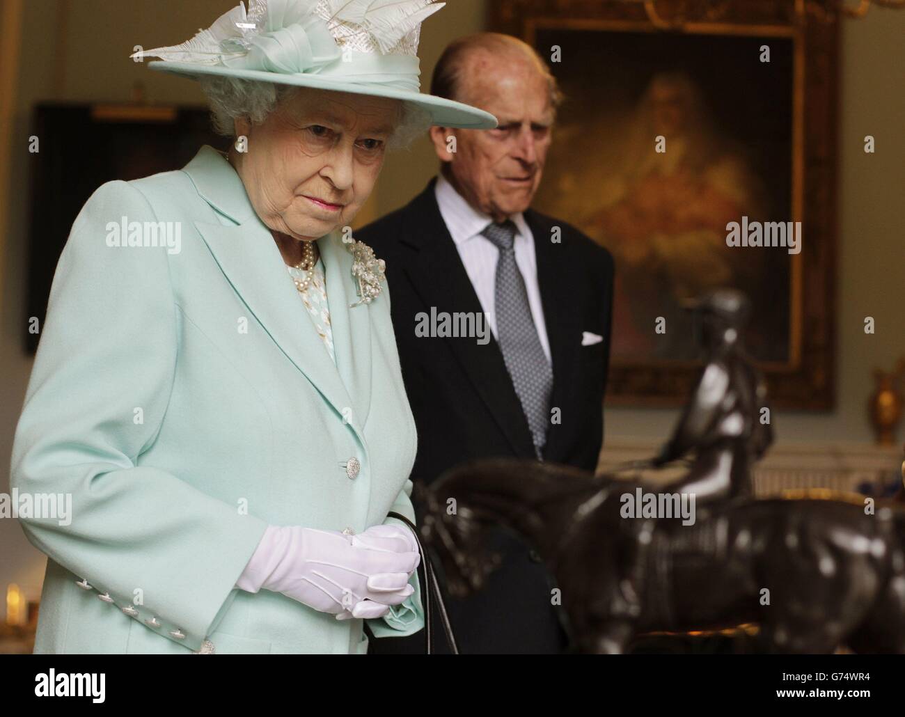 Queen Elizabeth II inspects a piece by French sculptor Pierre-Jules ...
