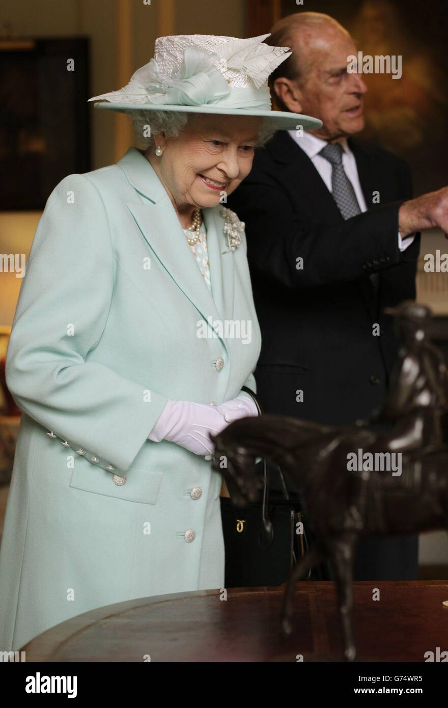 Queen Elizabeth II inspects a piece by French sculptor Pierre-Jules ...