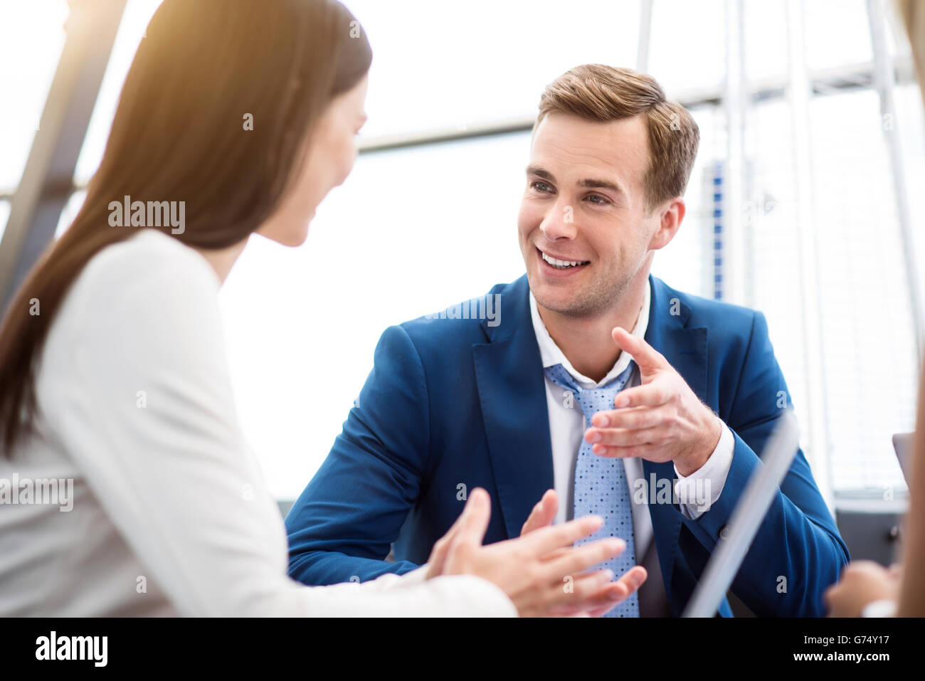 Positive pleasant colleagues talking Stock Photo - Alamy