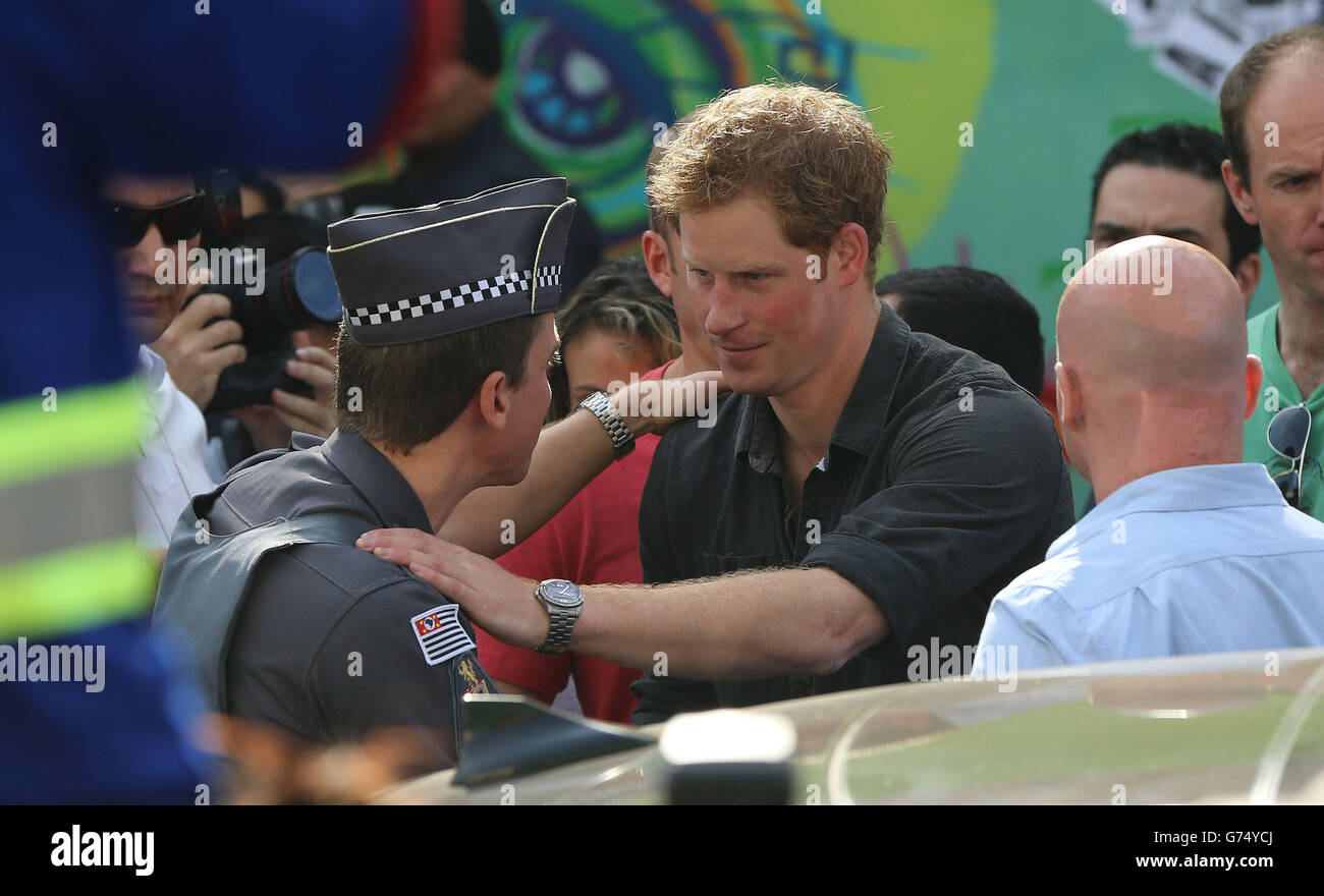 Prince Harry hugs a police officer as he visits the open arms project ...