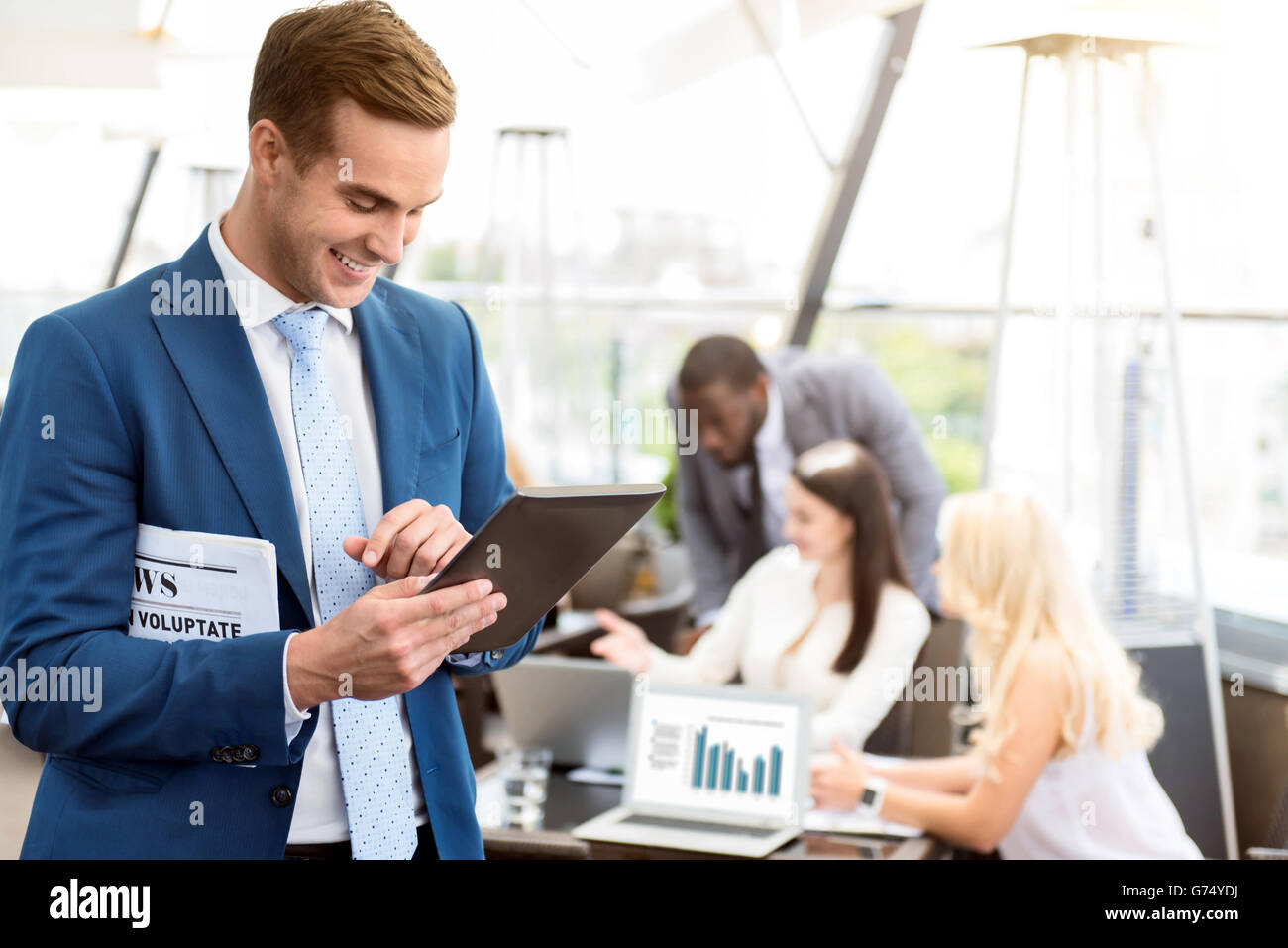 Handsome positive man standing in the office Stock Photo - Alamy