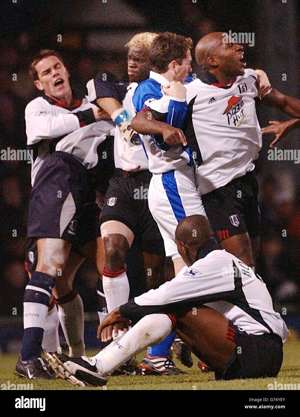 Barry Hayles, right, is restrained as fighting breaks out following a ...