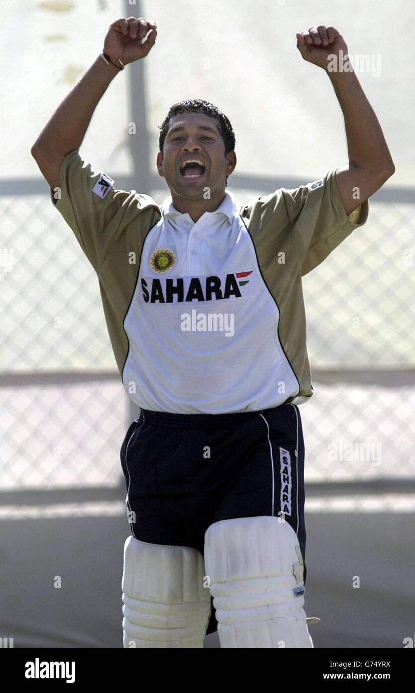 Indian batsman and part-time bowler Sachin Tendulkar celebrates a ...