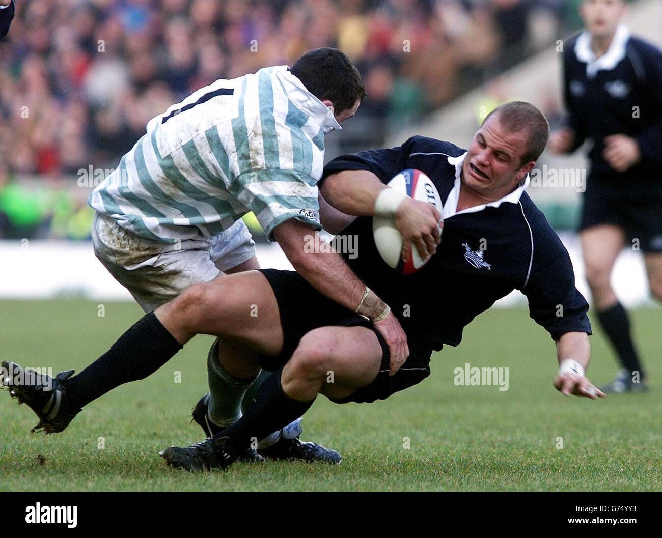 Peter Nicholas in the Dark Blue of Oxford is tackled by Cambridge's ...