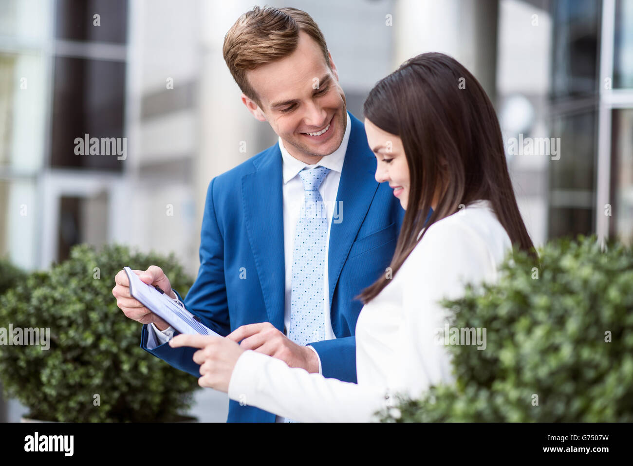 Pleasant cheerful colleagues talking Stock Photo - Alamy