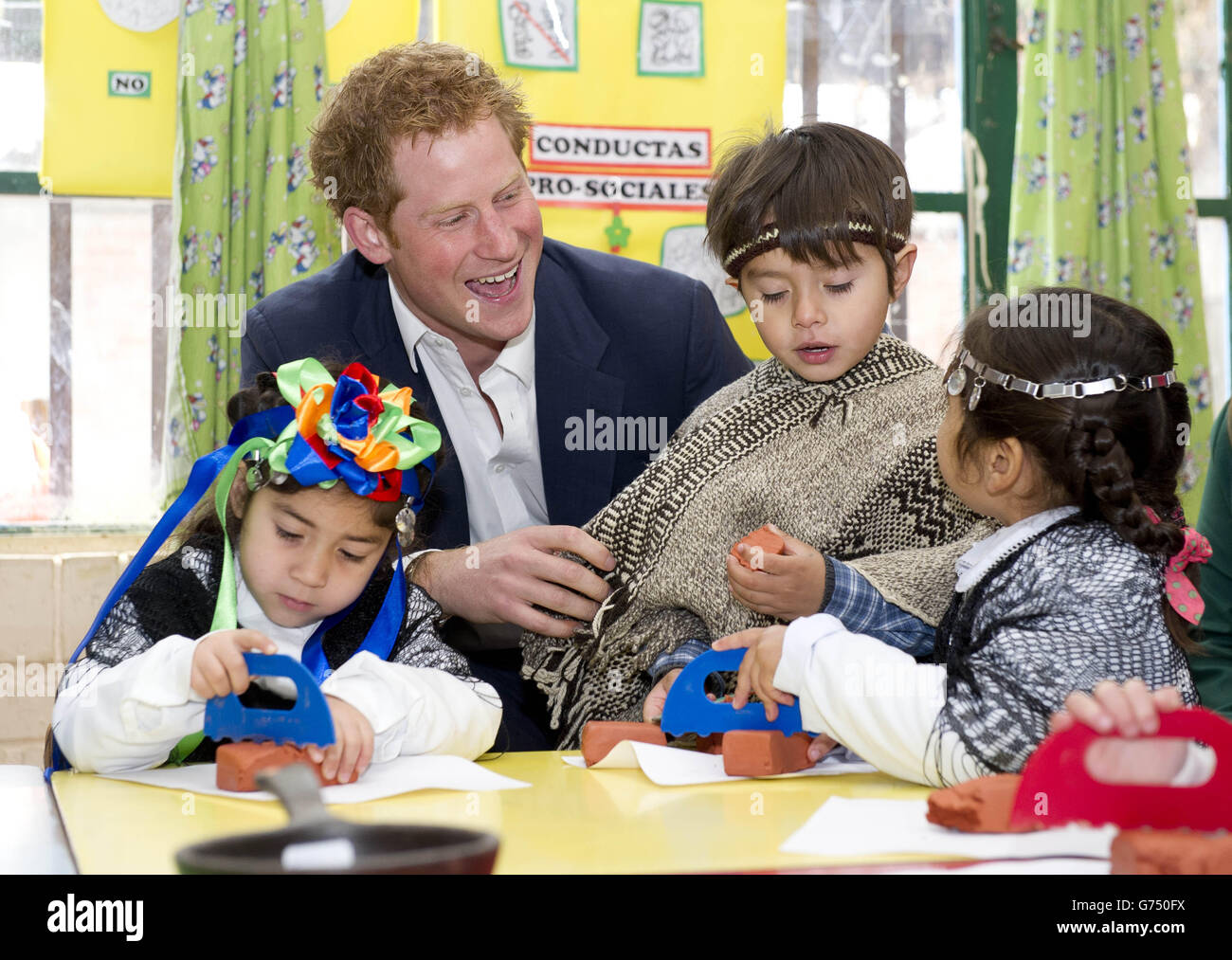 Prince Harry watches children partake in activities during a visit to a ...