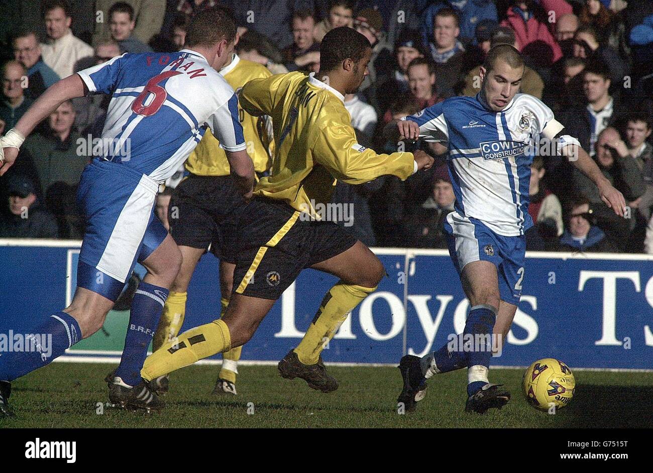 Torquay United's Richard Logan (centre) challenges Bristol Rovers ...