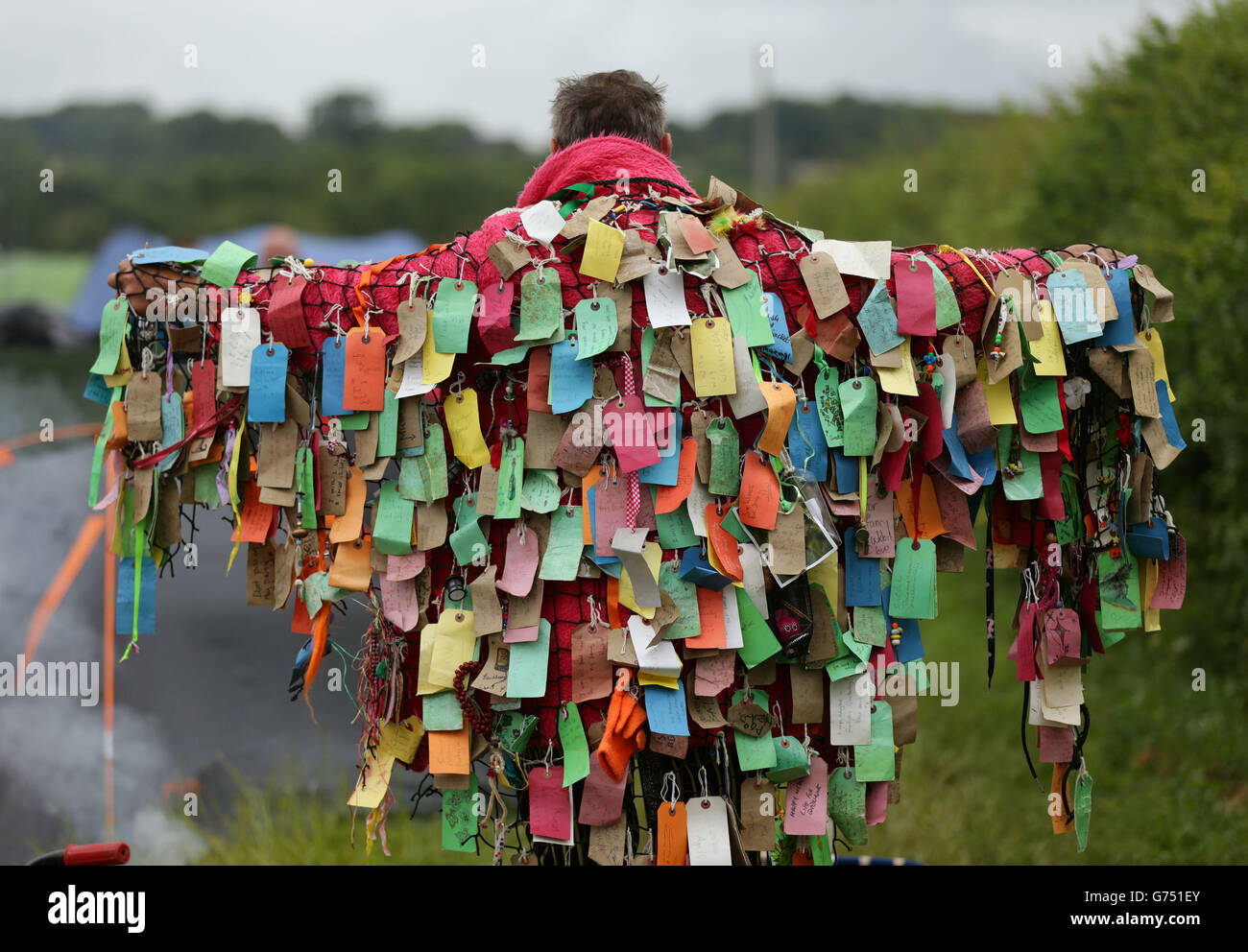 Malcolm Green wears a coat with luggage tags attached to it where ...
