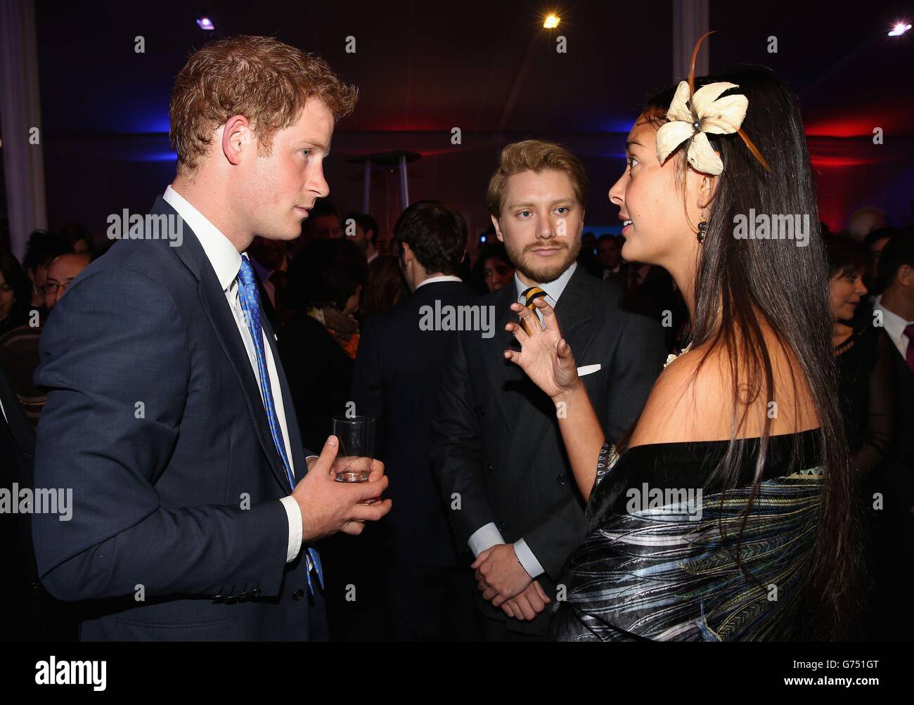 Prince Harry talks to guests at a Queen's Birthday Party event at the ...