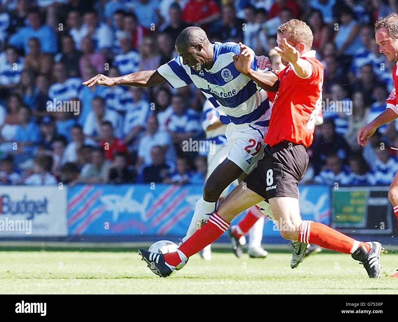 QPR's Paul Furlong (L) is challenged by Rotherham's Chris Swailes ...
