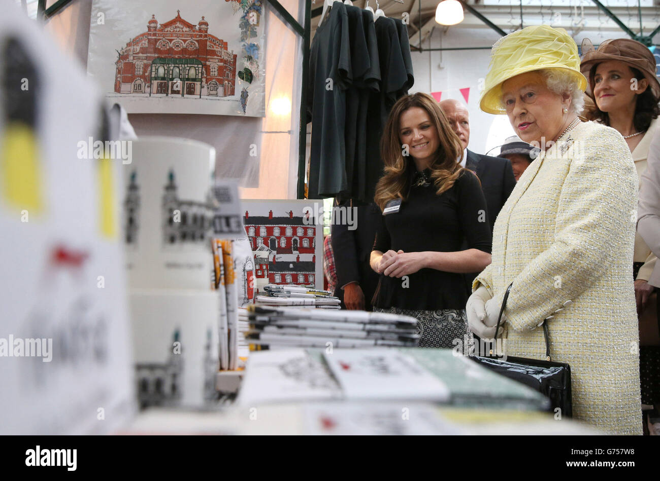 Queen Elizabeth II talks with stallholder Danielle Morgan during a walk ...