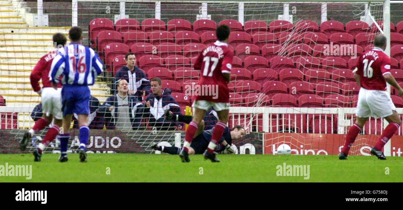 Swindon's captain Neil Ruddock (far right) scores the first goal from ...