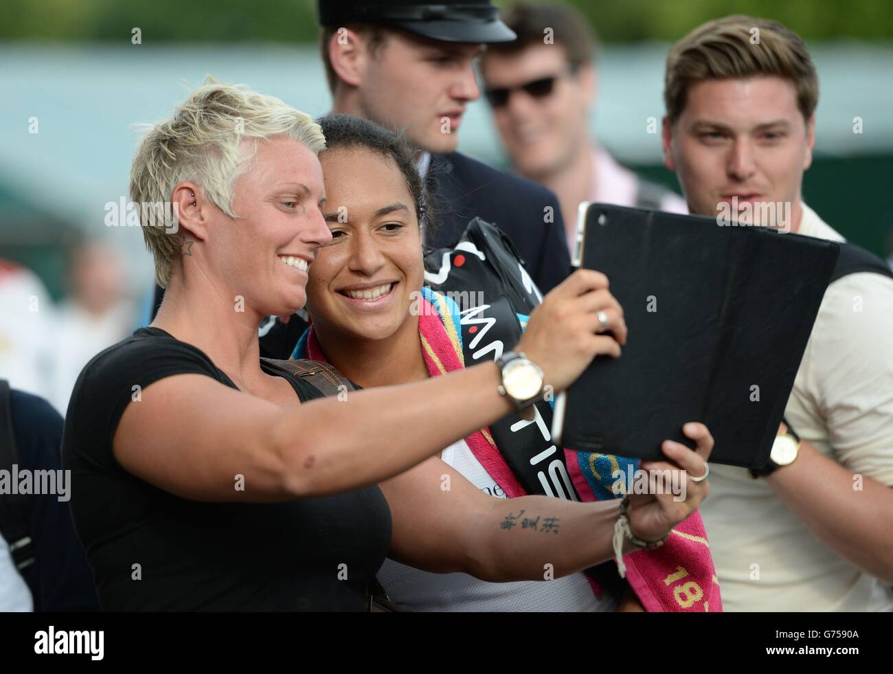Great Britain's Heather Watson has her photo taken with a fan following ...