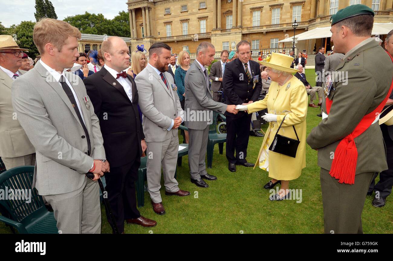 Queen Elizabeth II talks to a veteran while touring the 'Not Forgotten ...