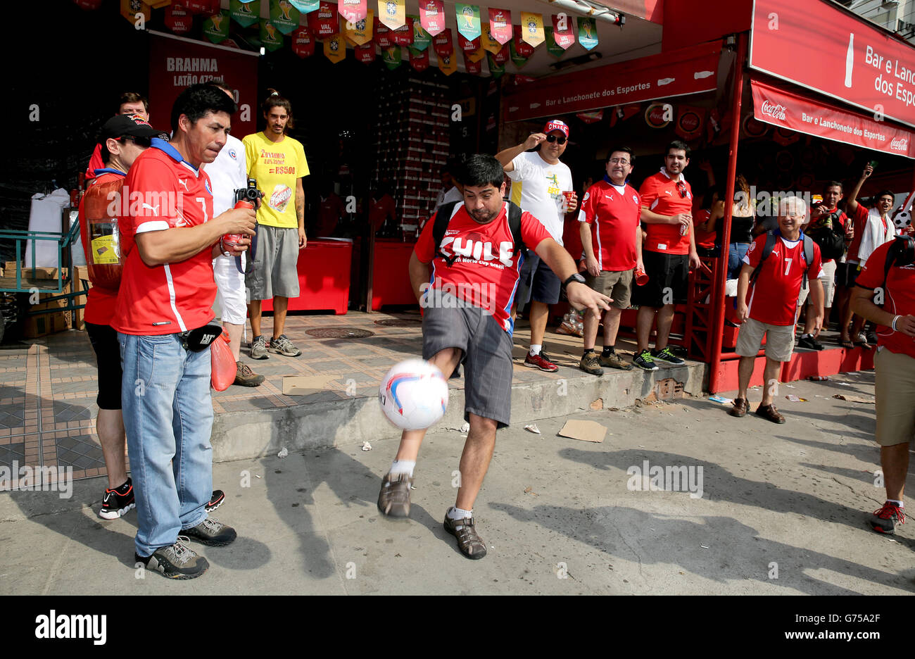 Chile fans play football outside the ground hi-res stock photography ...