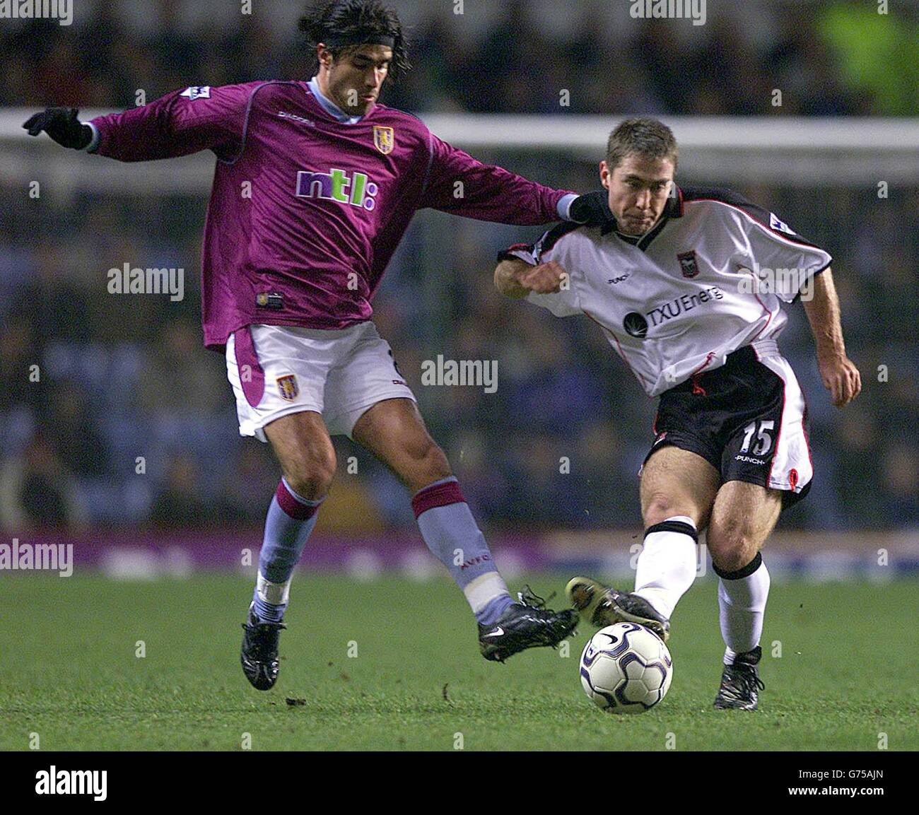 Ipswich Town's Chris Makin (R) makes his pass with the attention of ...