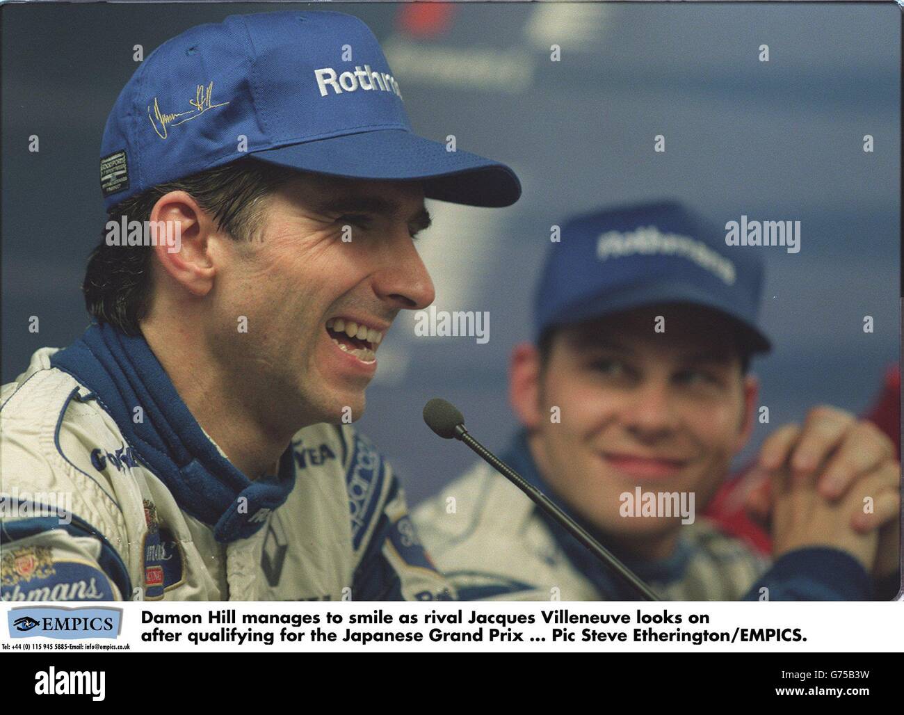Damon Hill manages to smile as rival Jacques Villeneuve looks on after ...