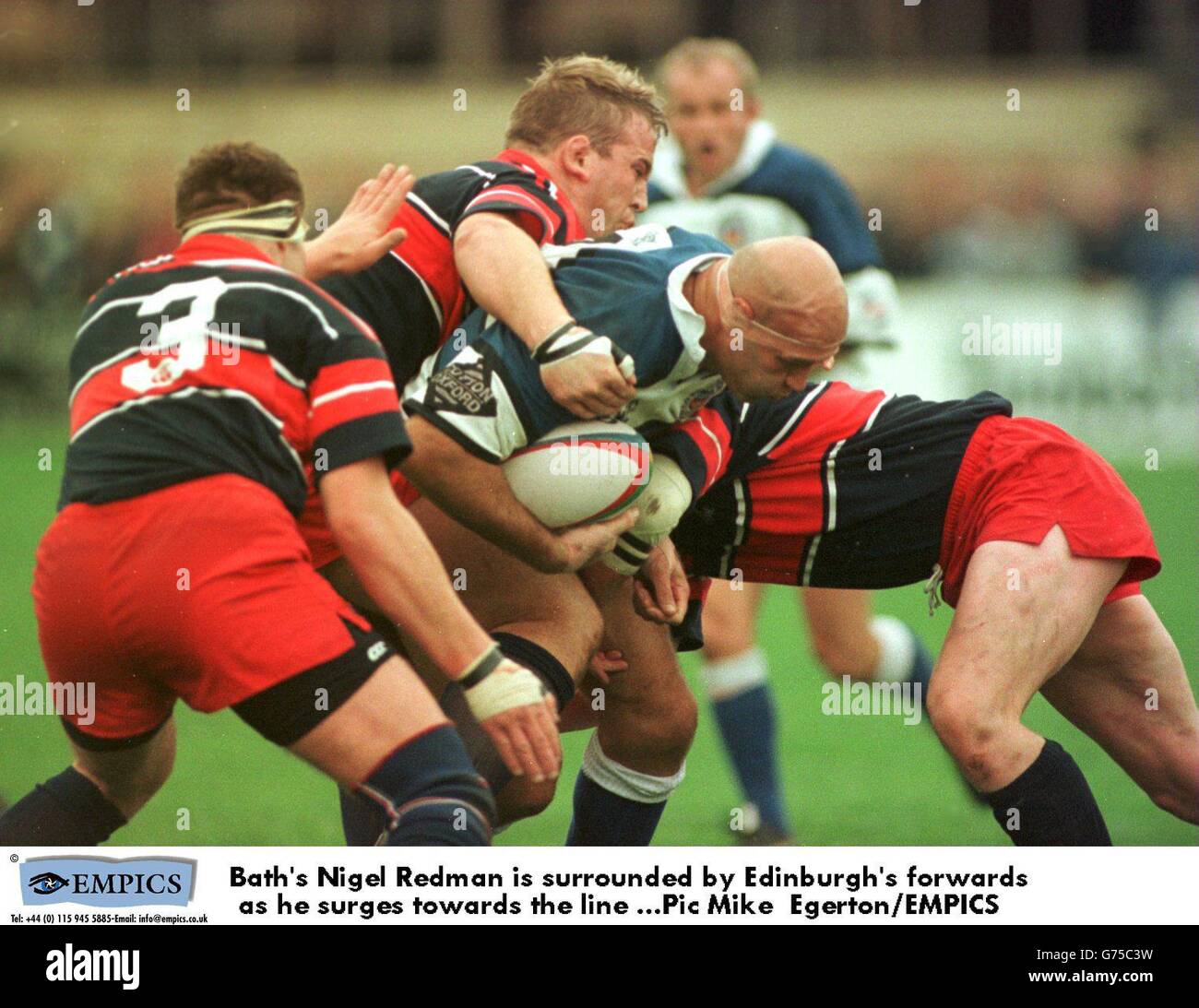 Bath's Nigel Redman is surrounded by Edinburgh's forwards as he surges ...