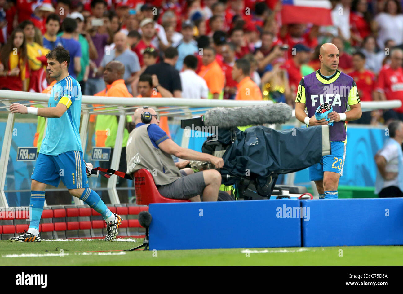 Spain goalkeeper Iker Casillas (left) leaves the field dejected as ...