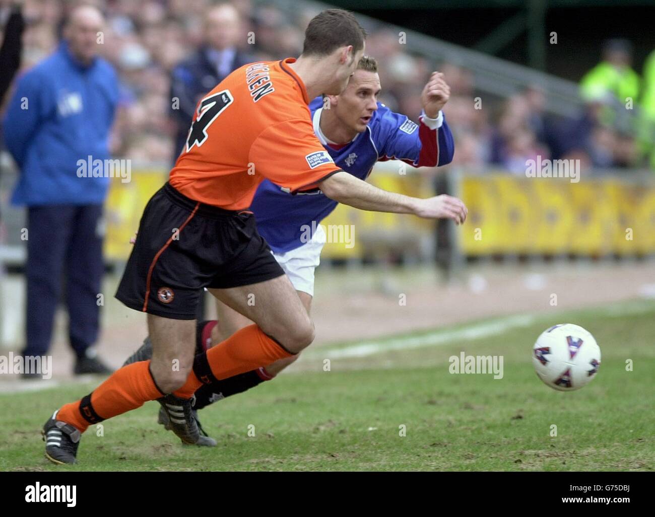 Rangers' Peter Lovenkrands (right) breaks past Dundee United's David ...