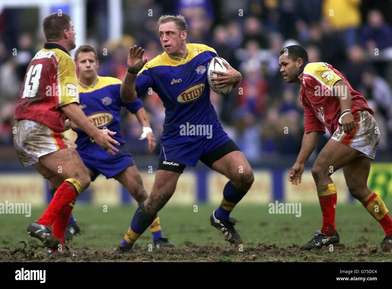 Leeds's Andy Hay (centre) hands off London's Matt Toshack (left) and ...