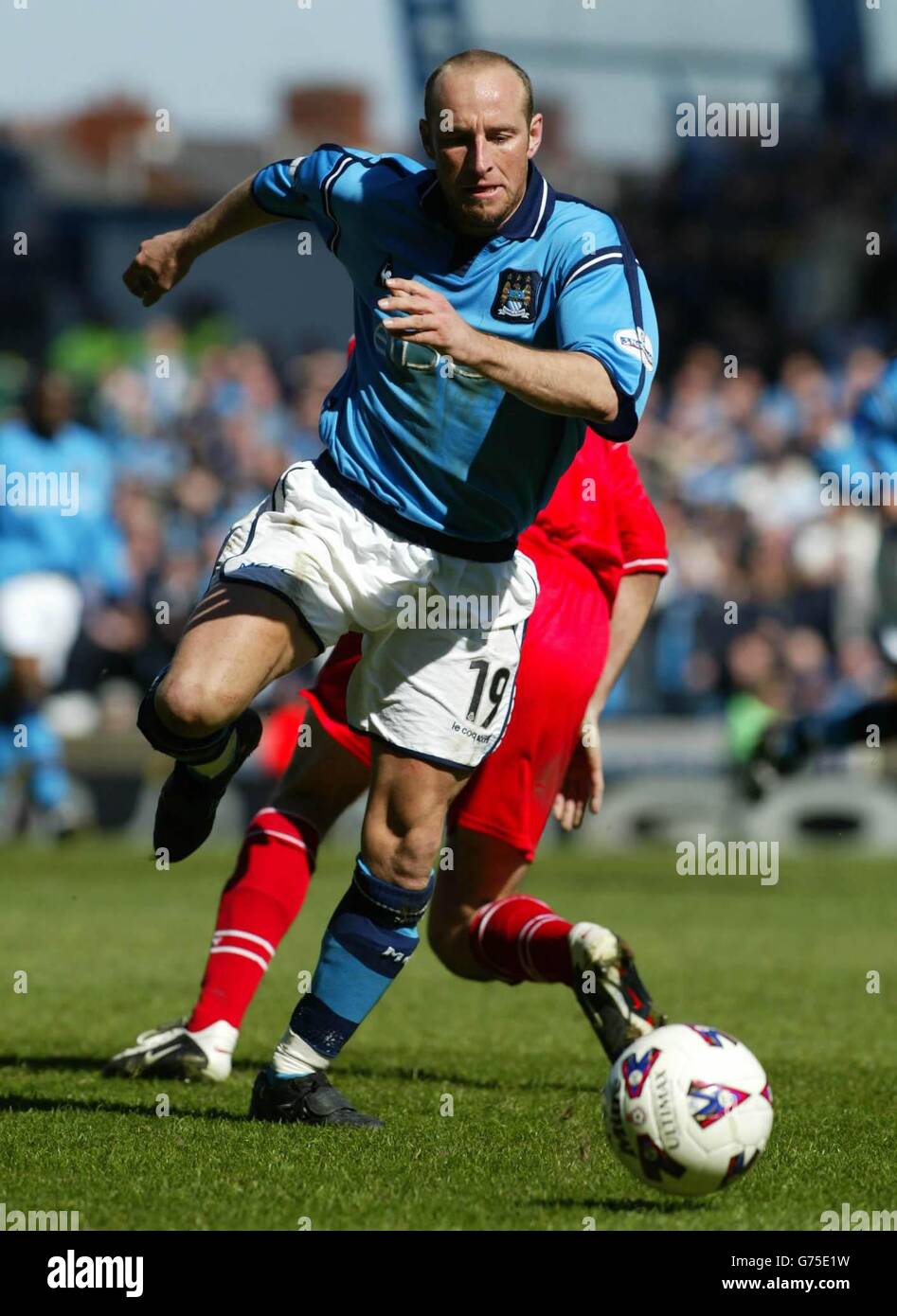 Manchester City's Danny Tiatto escapes the attentions of Barnsley's ...