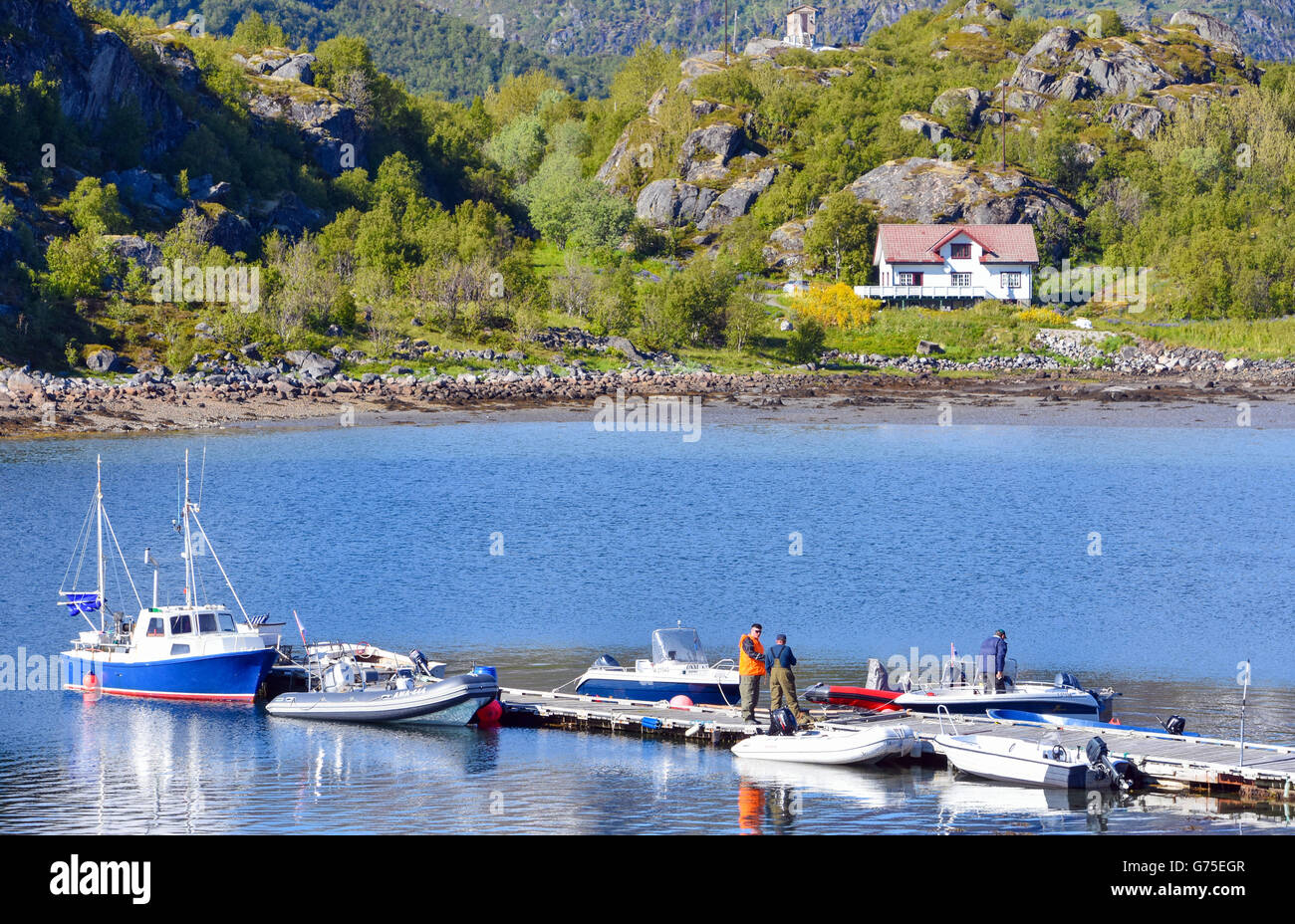 Boats moored at jetty with fishermen Orsvagvaer, Sandvik camping areas ...