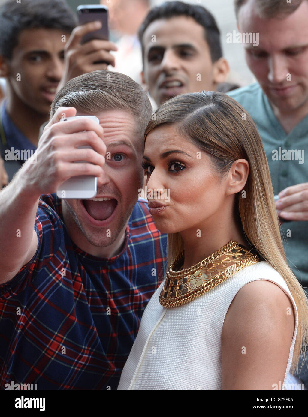 Judge Cheryl Cole poses for photographs with fans as she arrives at the ...