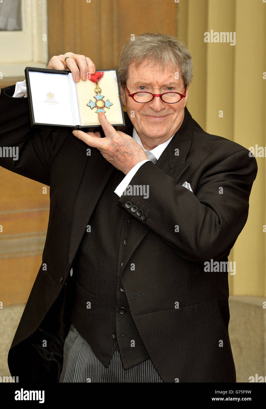 John Copley proudly holds his CBE (Commander of the British Empire ...