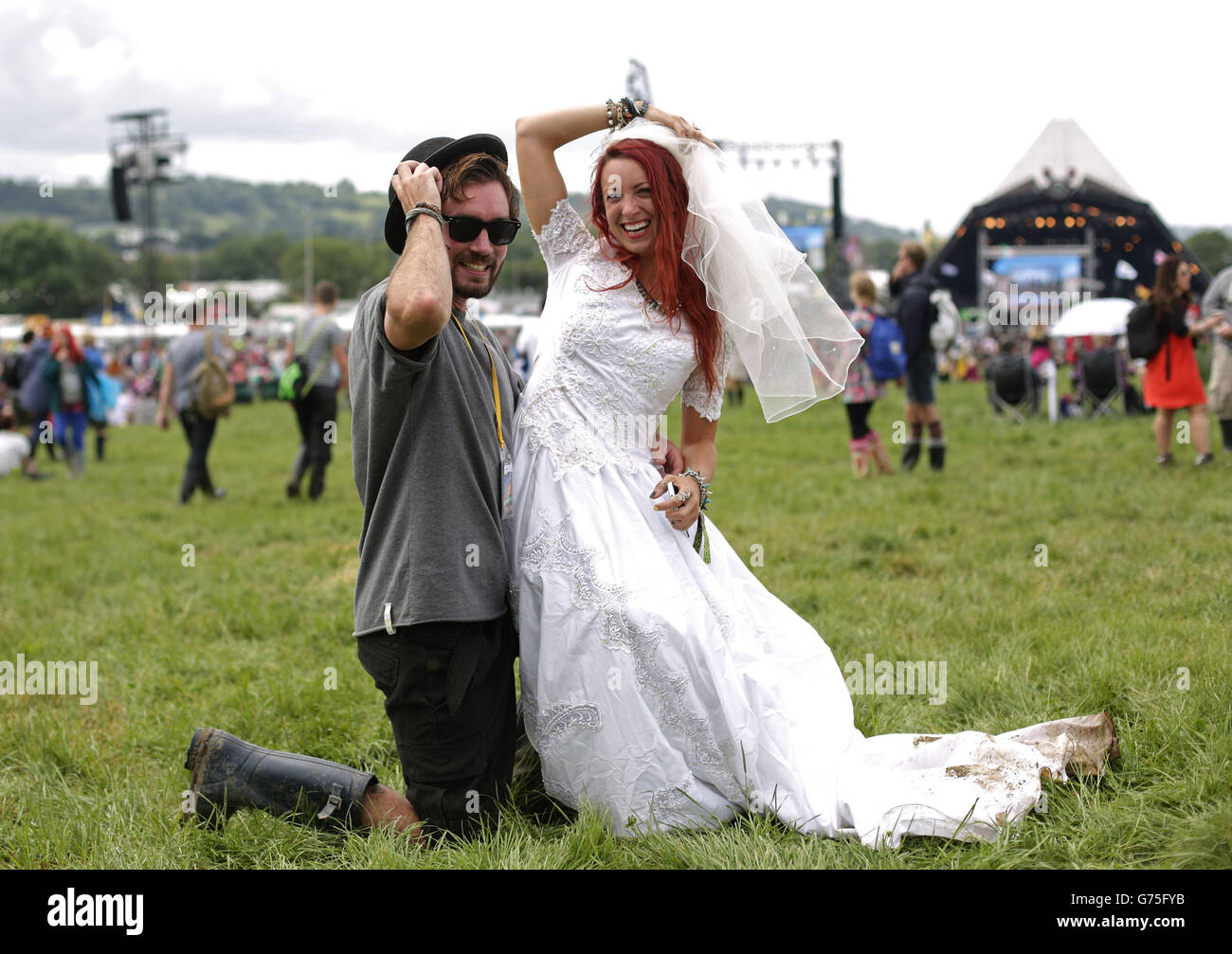 Festival goers and newly-weds Craig Reilly, aged 28, and Hannah Lomas ...