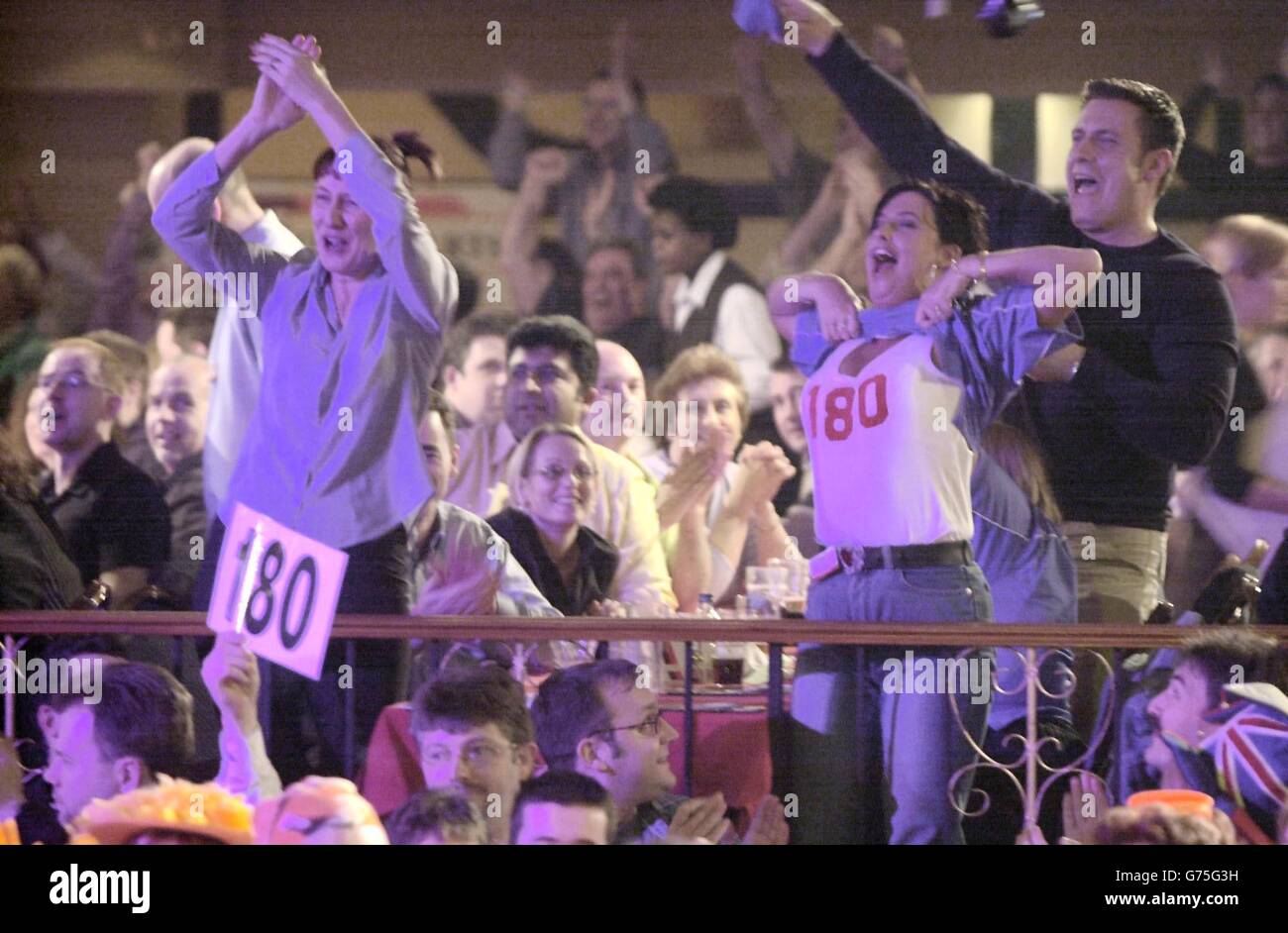 Jubilant spectators celebrate a 180 score during the semi-final match ...