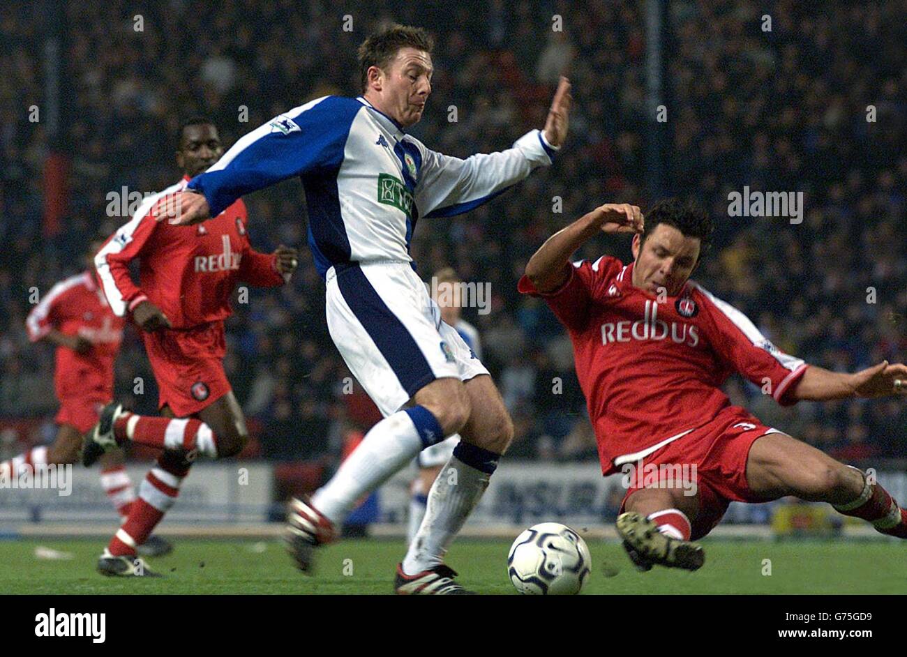 Blackburn's Craig Hignett (centre) shoots past Charlton's Mark Fish ...