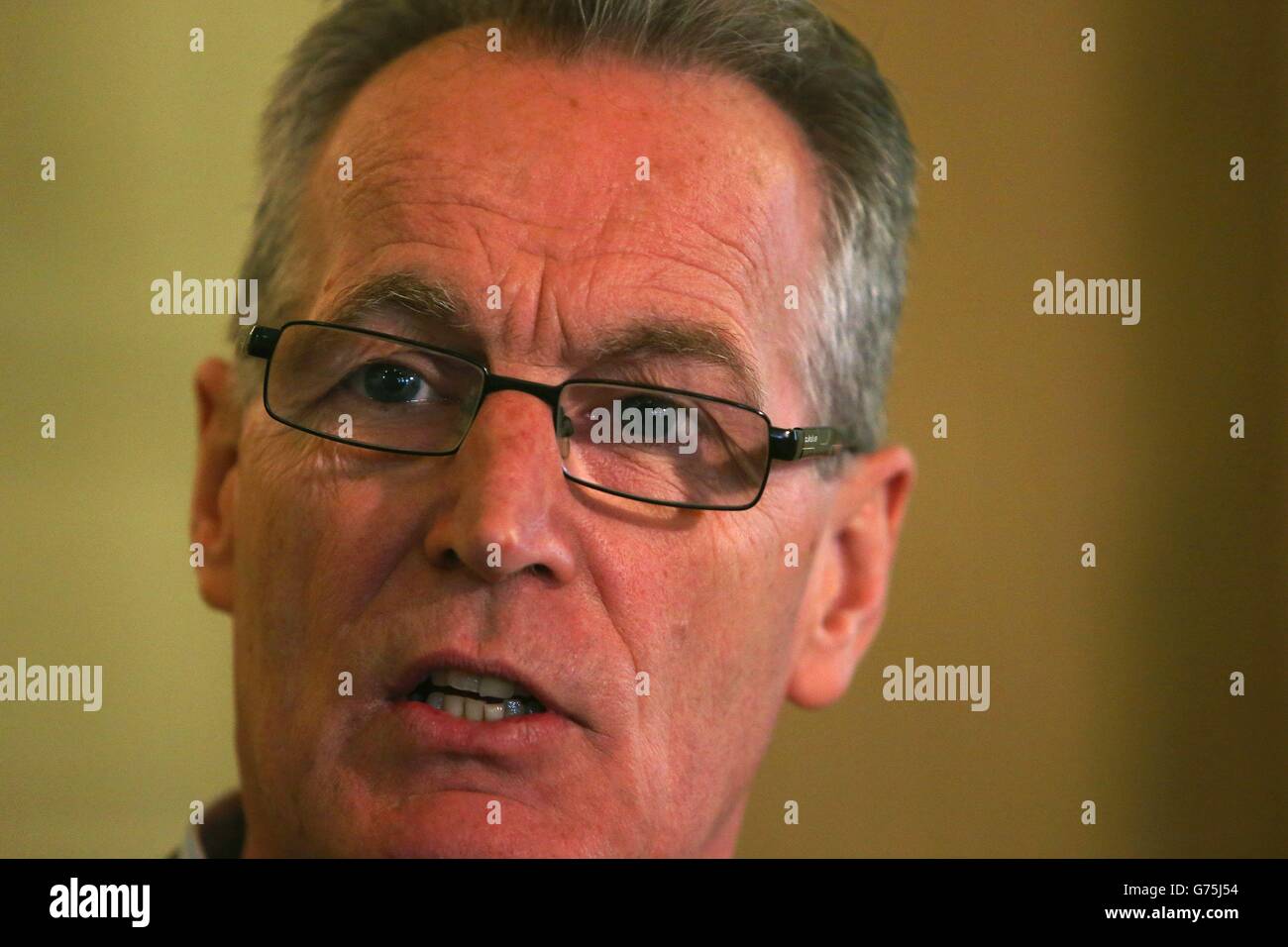 Gerry Kelly, of the Sinn Fein negotiation team, speaks to the media ...
