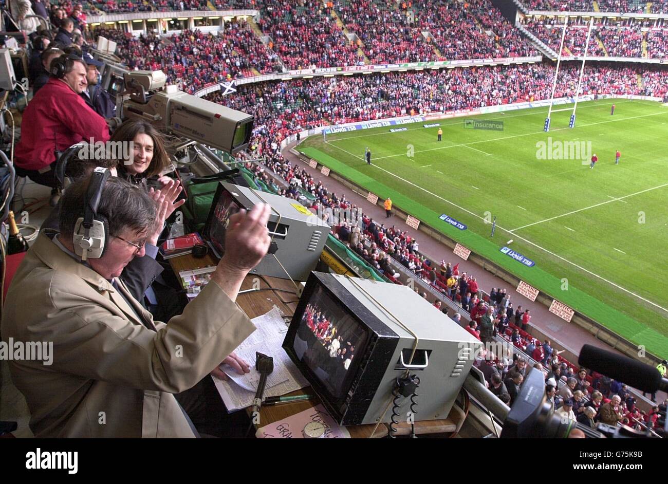 BBC commentator Bill McLaren waves to the crowd from his gantry ...
