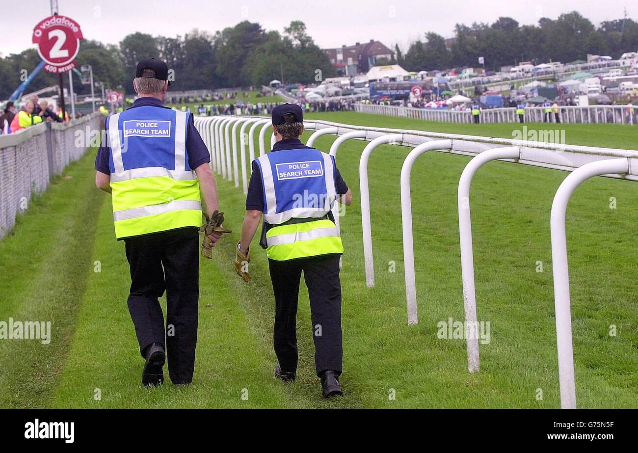 Epsom Races/ Security. Police search team walk alongside the railings ...