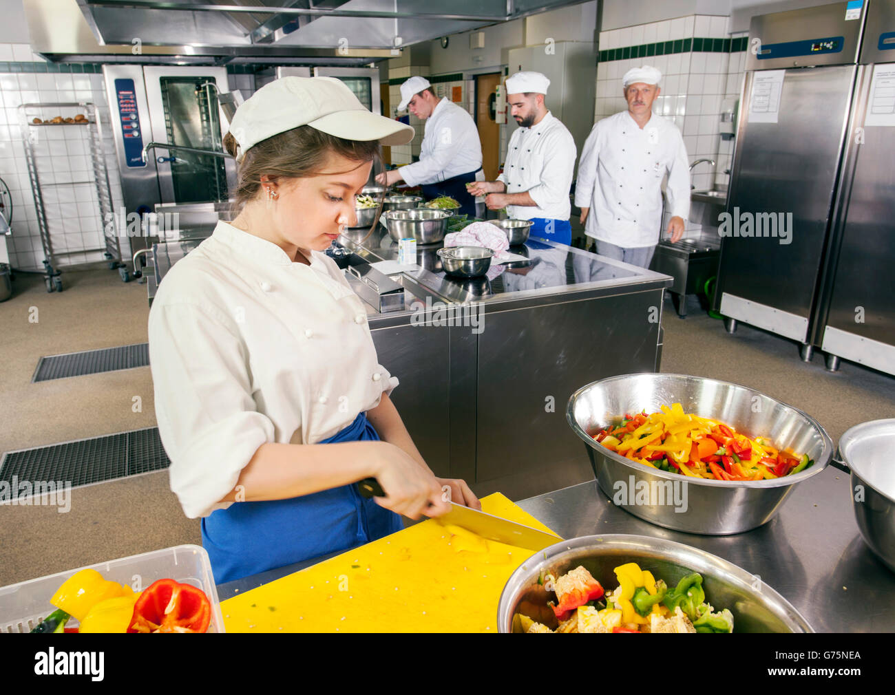 Apprentice cook cut paprika for lunch Stock Photo - Alamy