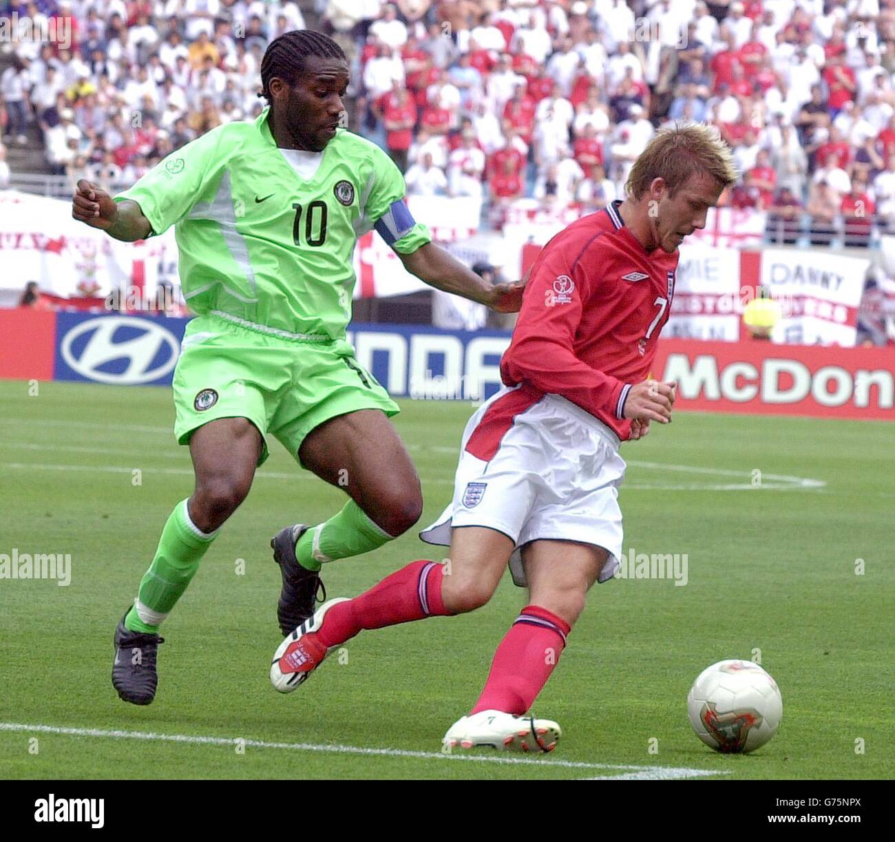 England's David Beckham (right) goes past Jay Jay Okocha of Nigeria ...