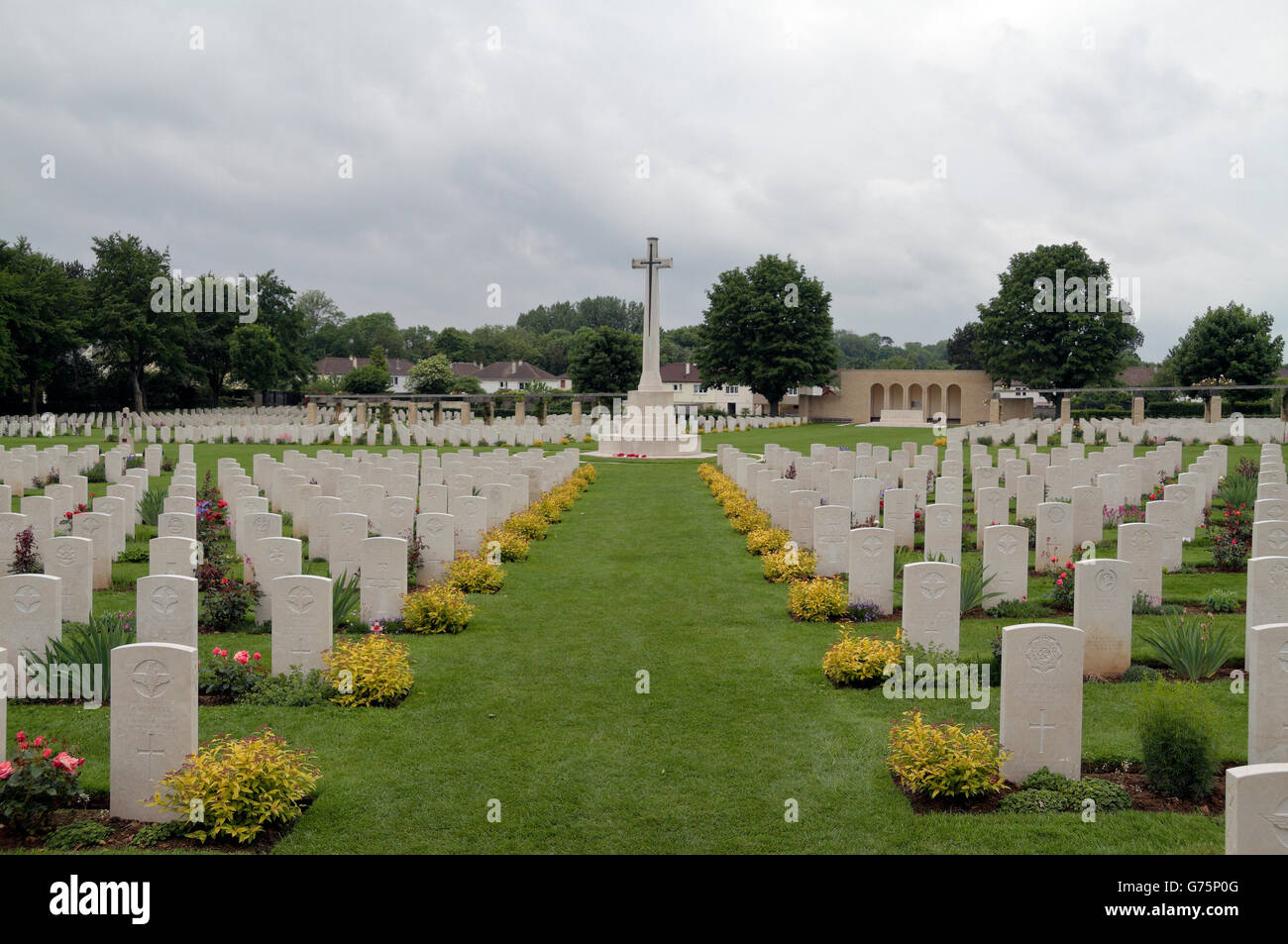 Cross of Sacrifice and headstones in the CWGC Ranville War Cemetery ...