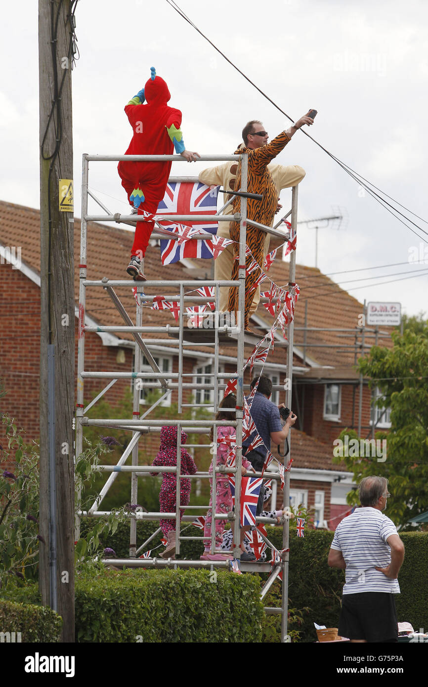 Spectators wearing fancy dress take to a scaffolding as the Tour de ...