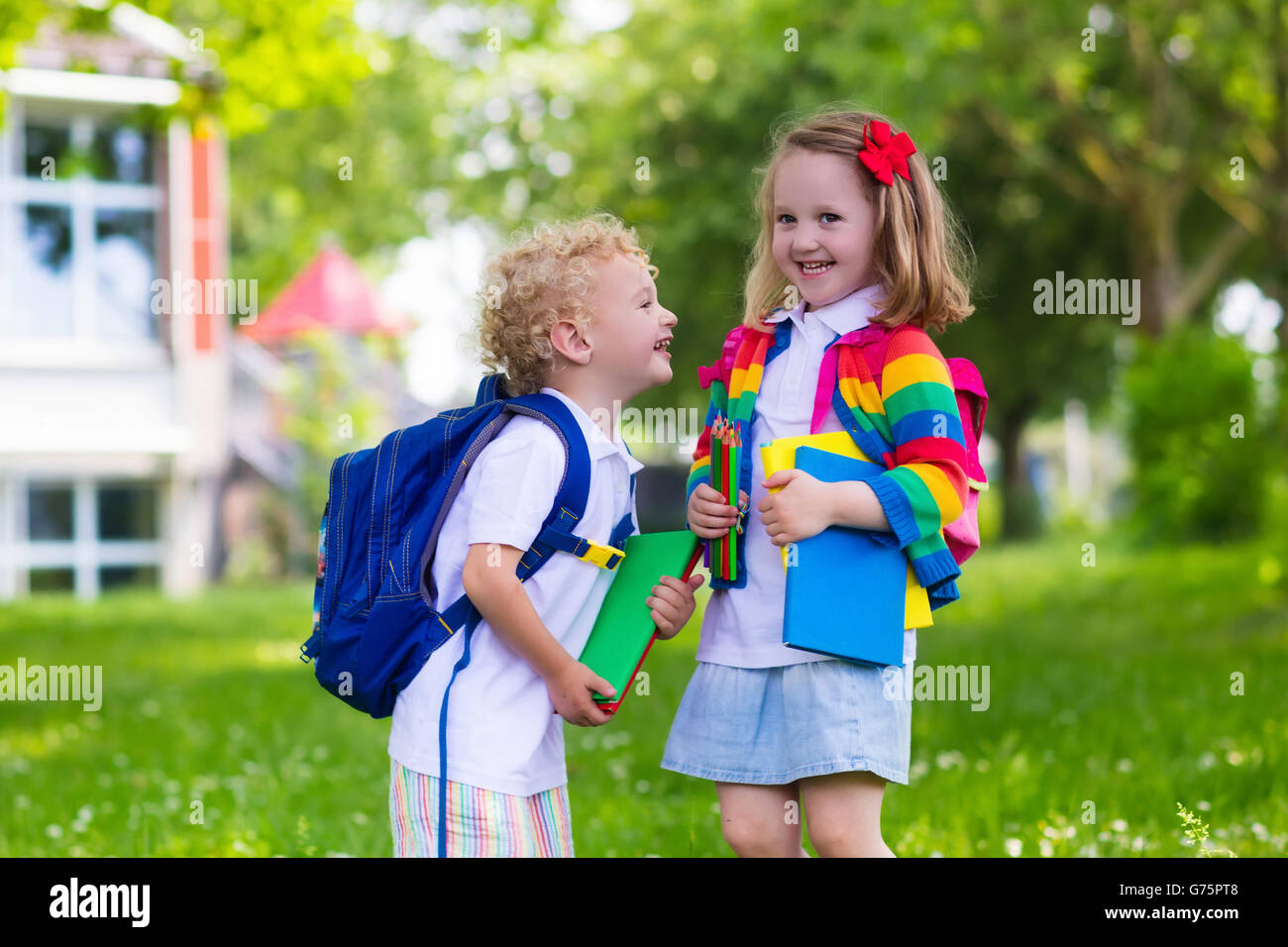 Child going to school. Boy and girl holding books on the first school ...