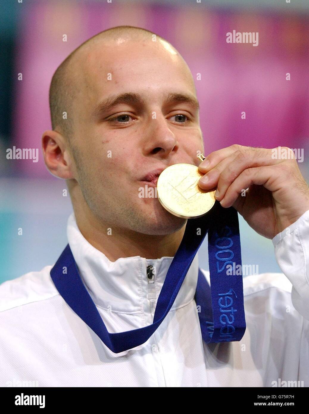 England's Pete Waterfield kisses his medal after winning gold in the ...