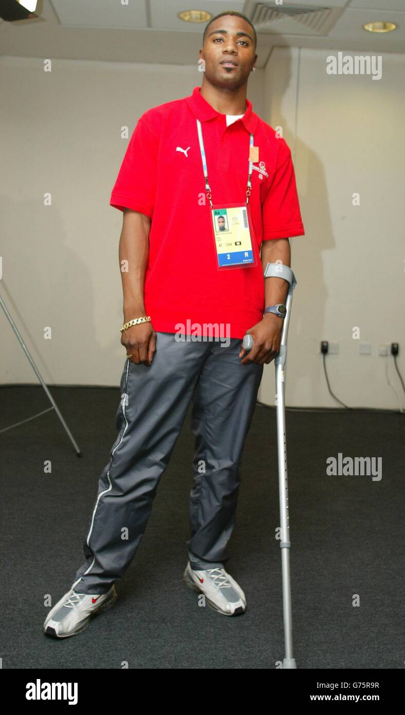 England's sprinter Mark Lewis-Francis arrives on a crutch for a press ...
