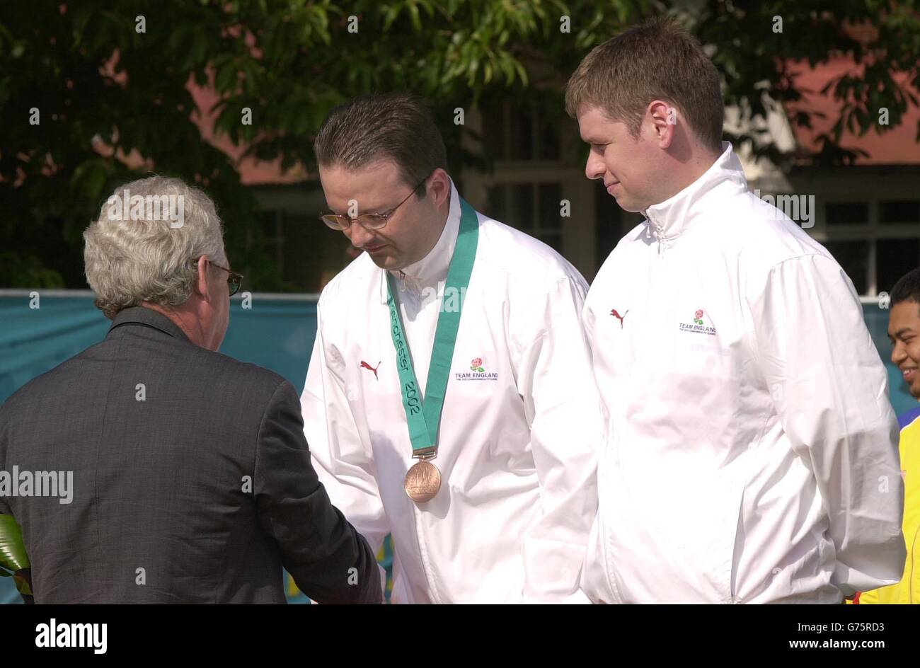 Nigel Wallace (centre) and Christopher Hector receive their bronze ...