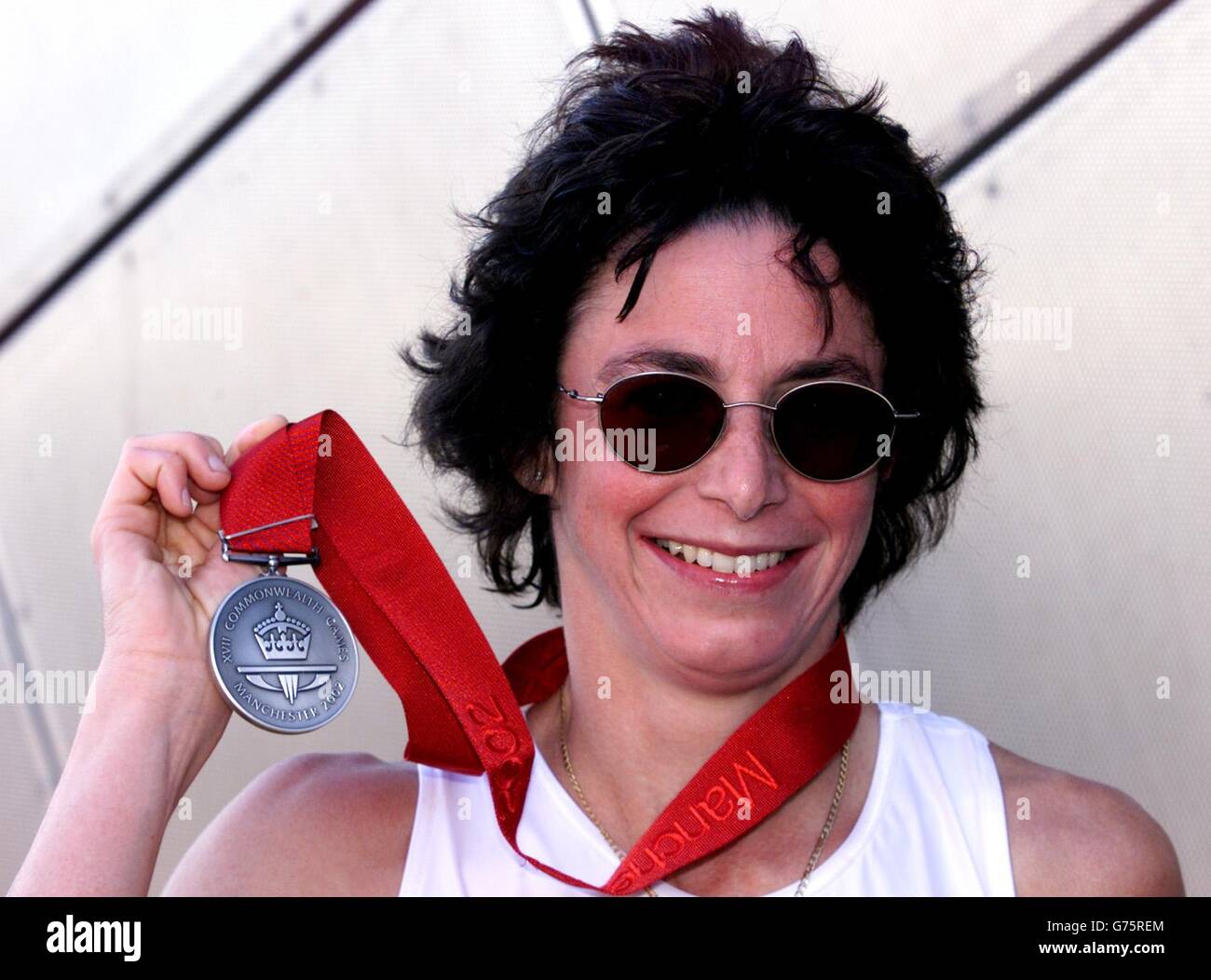 England's Lisa Kehler smiles as she holds her silver medal for the ...
