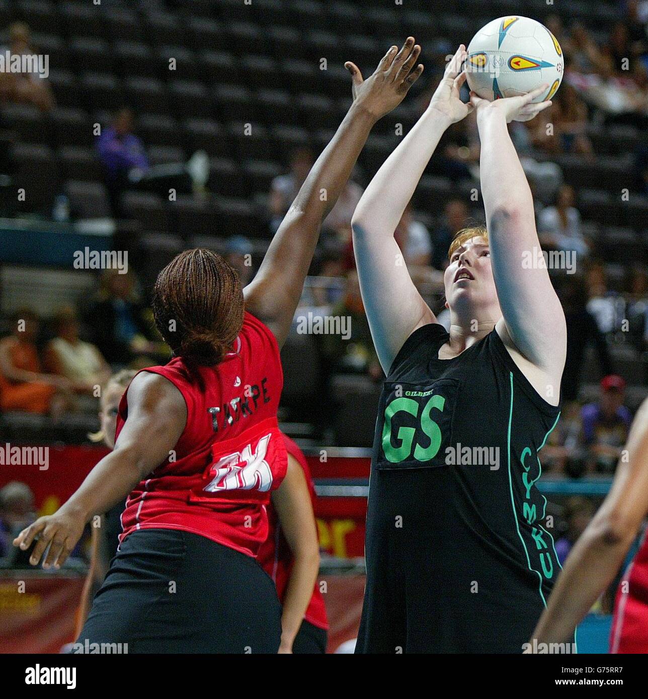 Wales Goalshooter Mair Jones (R) shoots over Canada's Goalkeeper Sheryl ...