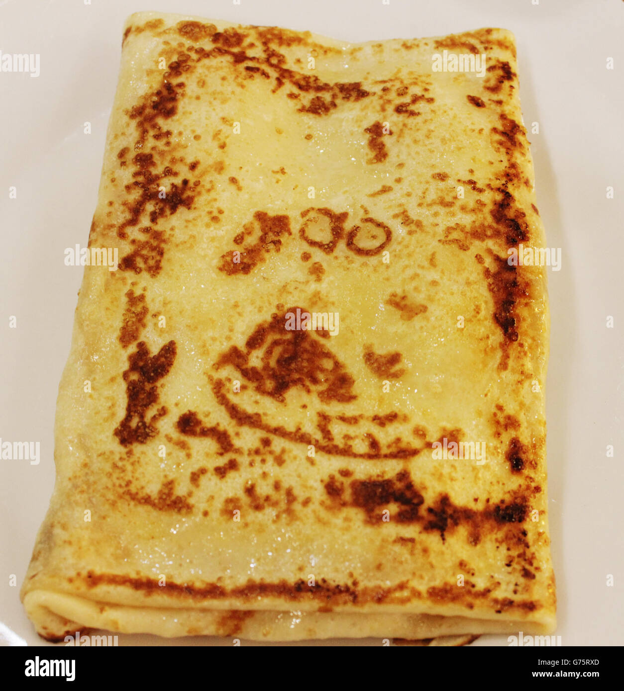 single square pancake with smile on a white plate Stock Photo - Alamy
