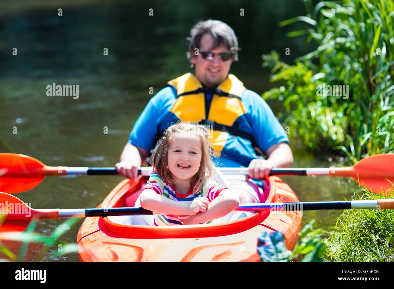 Family on kayaks and canoe tour. Father and child paddling in kayak in ...