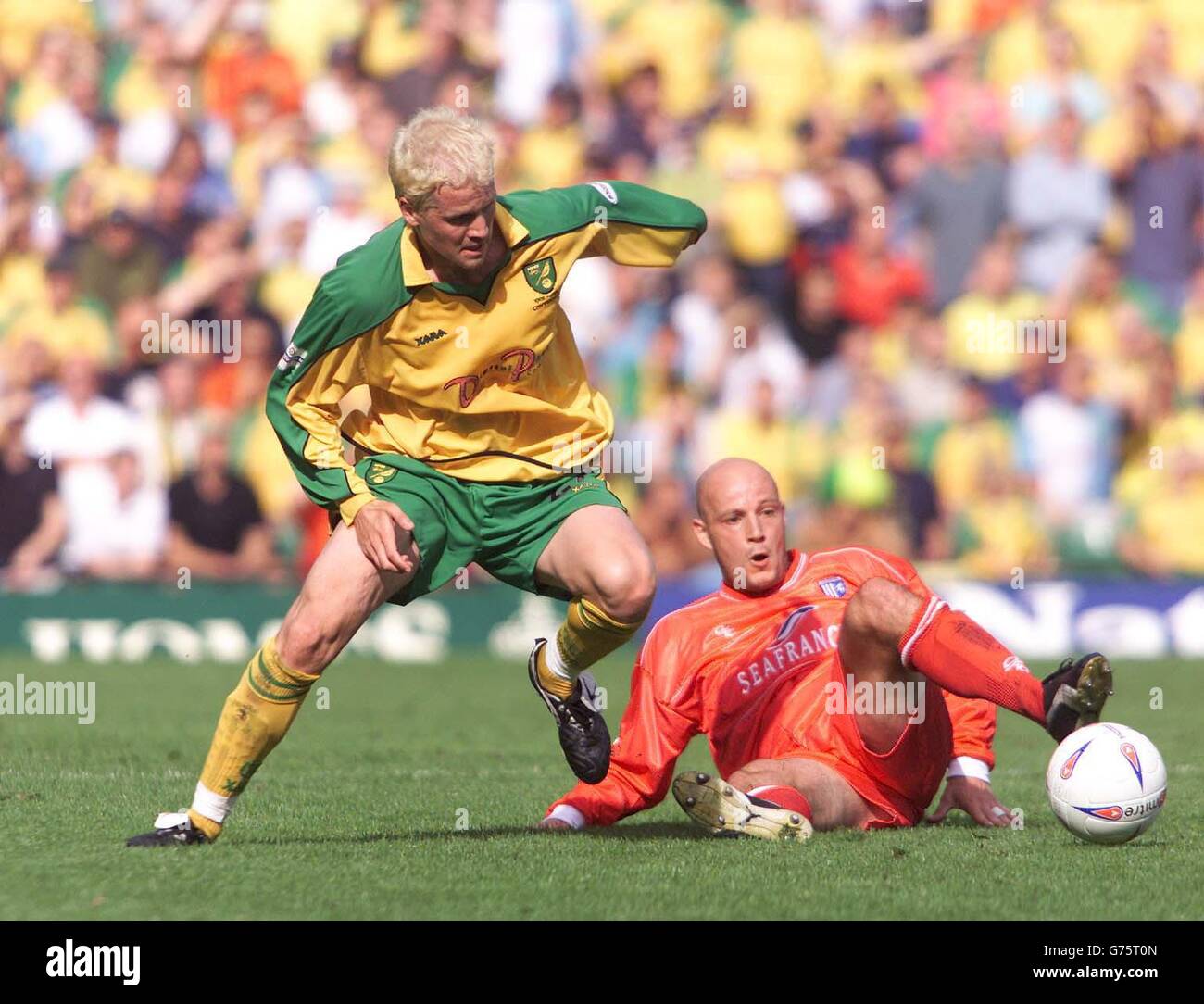 Norwich's Mark Rivers (left) in action against Gillingham's Paul Shaw ...