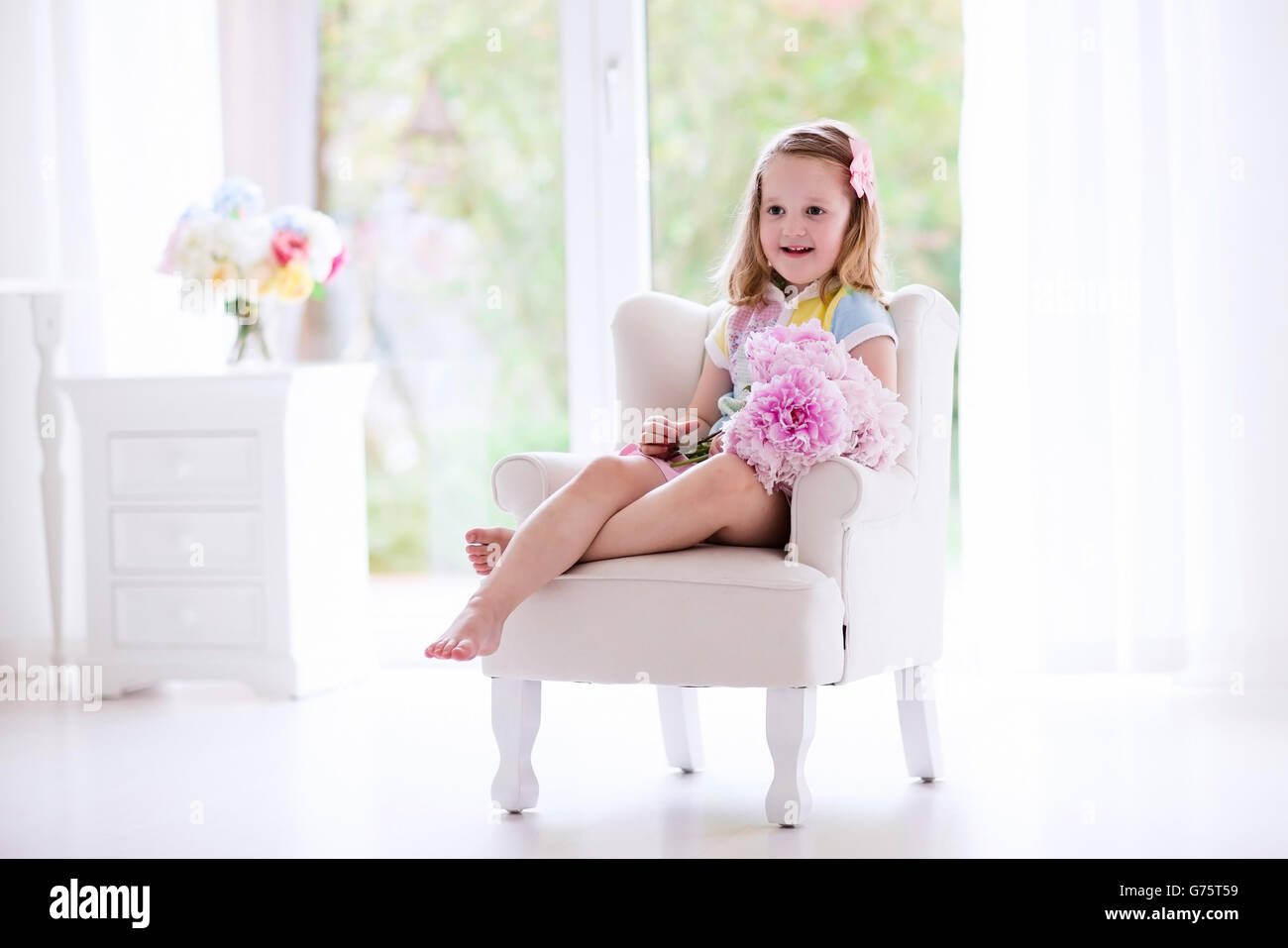 Little girl smelling at peony hi-res stock photography and images - Alamy